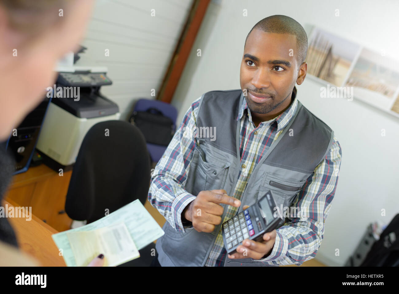 man shows price to client in office Stock Photo - Alamy