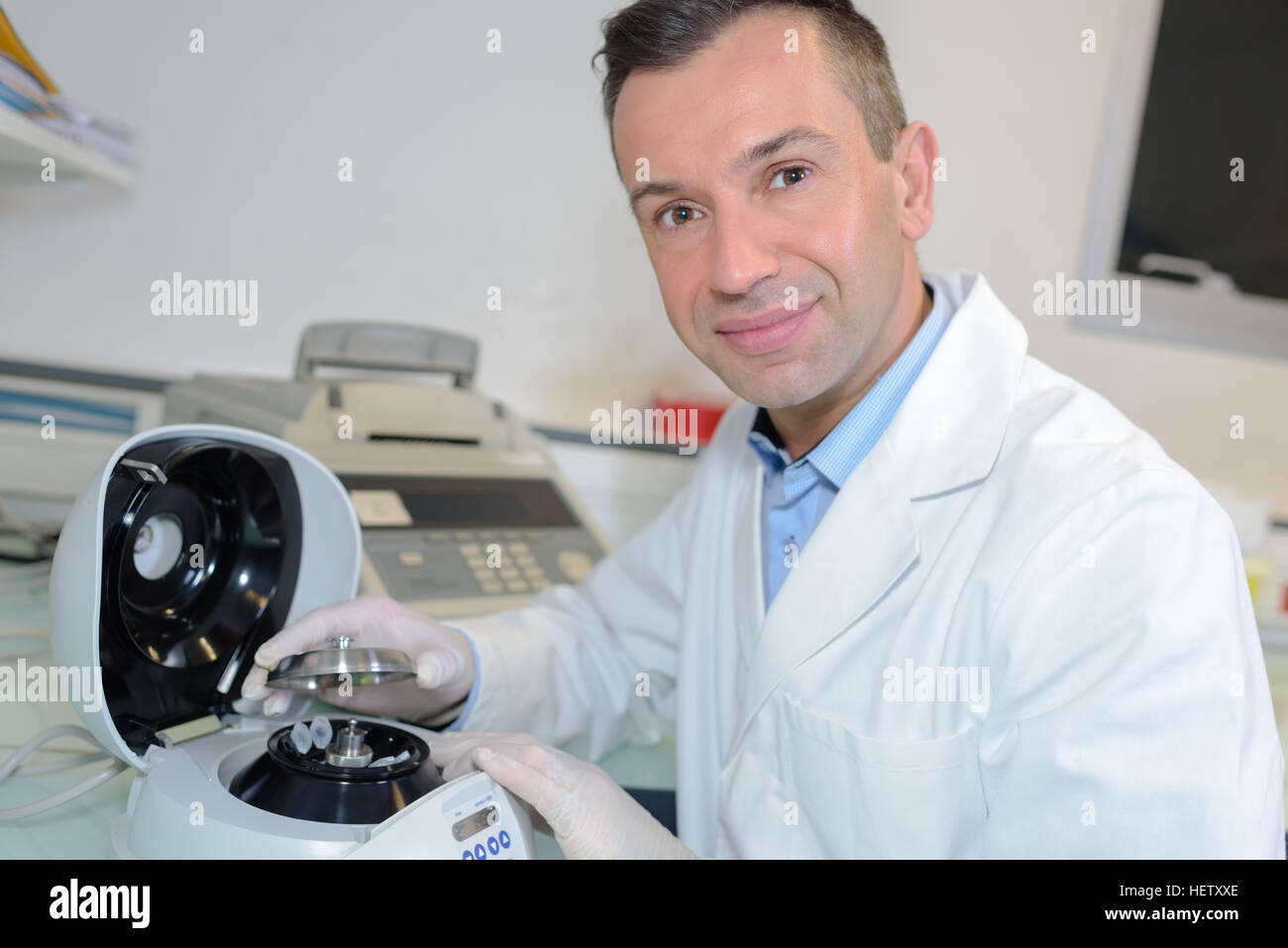 Portrait of laboratory technician with centifugal machine Stock Photo ...