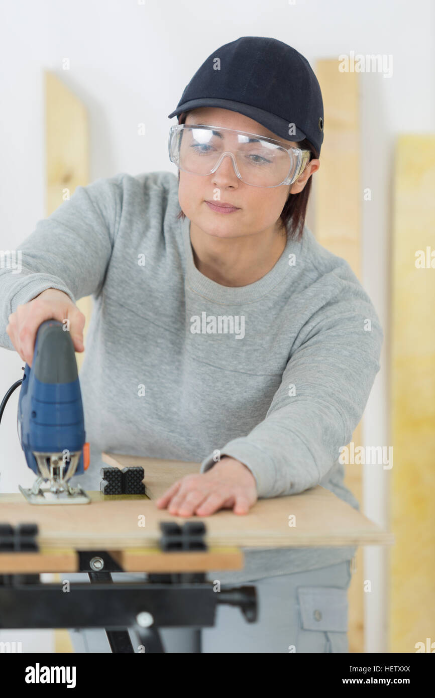 Woman using electric saw hi-res stock photography and images - Alamy