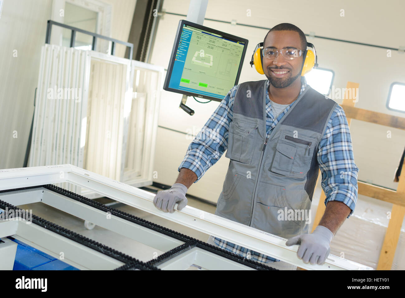 Male worker manufacturing windows Stock Photo - Alamy