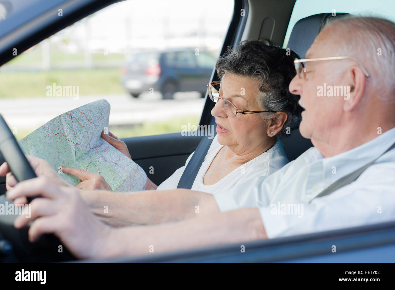 Elderly couple in car, looking at map Stock Photo - Alamy