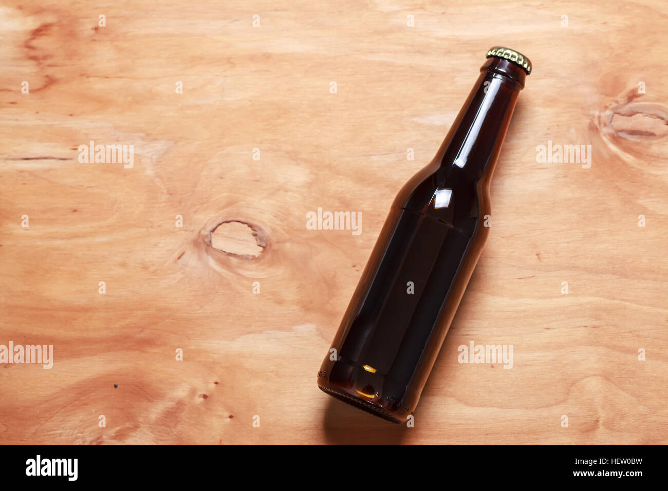 Beer bottle with no label on a textured wooden surface Stock Photo - Alamy