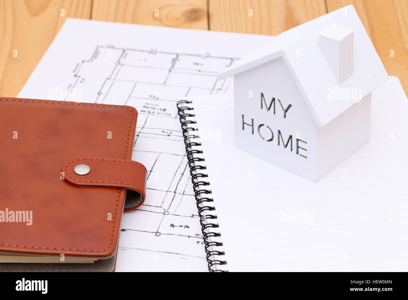 Miniature model of house and blueprints, construction plan Stock Photo ...