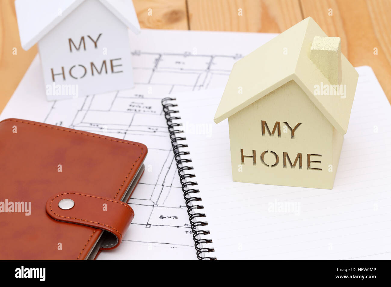 Miniature model of house and blueprints, construction plan Stock Photo ...