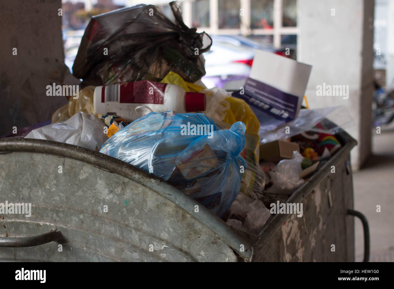 Outdoor trash bin with food waste. Not sorted garbage, yard, stench ...