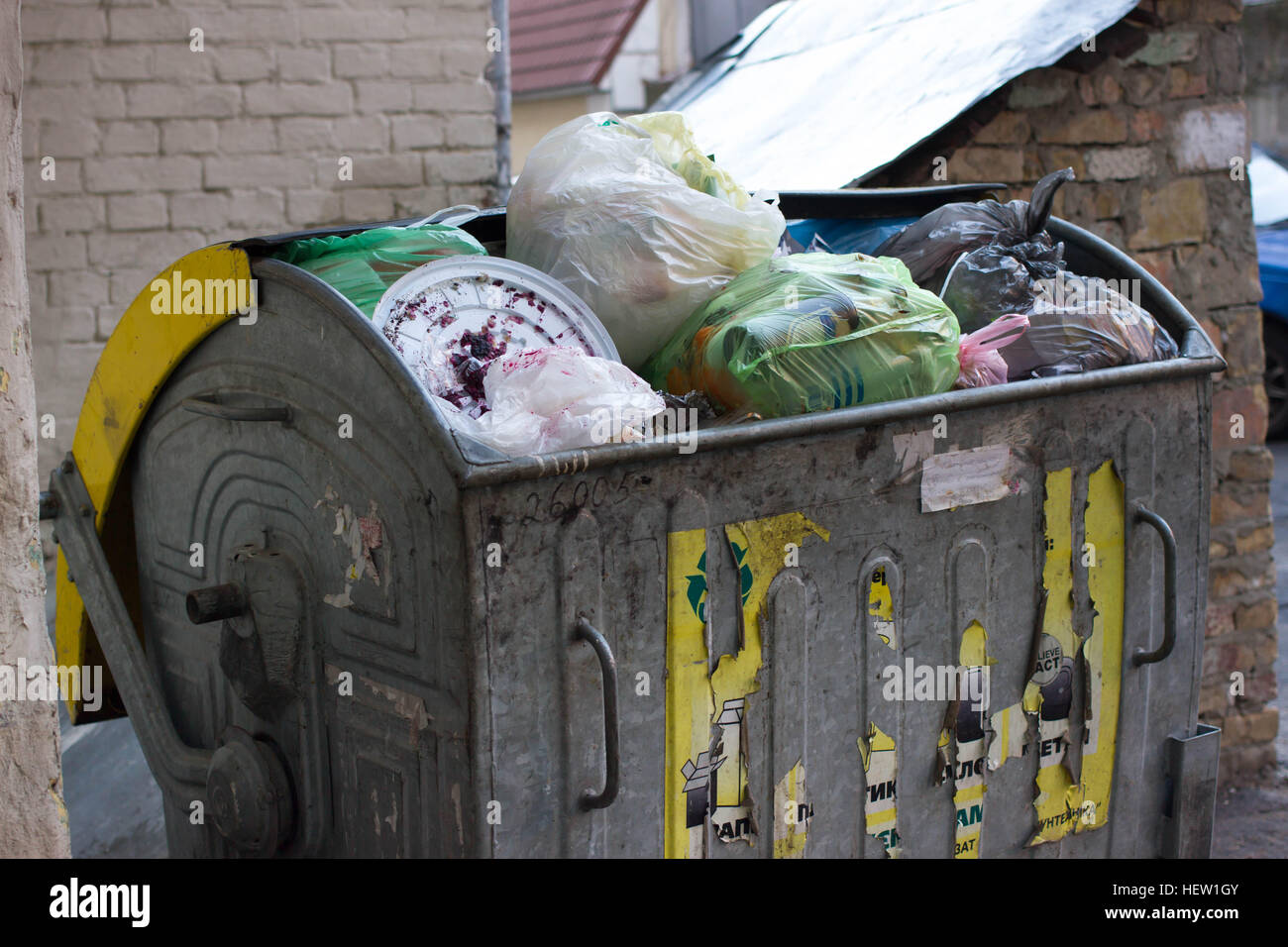 Outdoor trash bin with food waste. Not sorted garbage, yard, stench ...