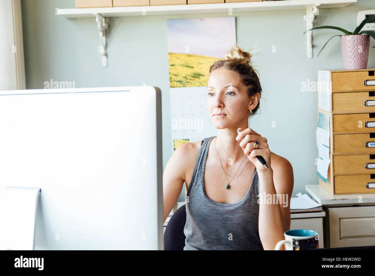 Woman in office using computer Stock Photo - Alamy