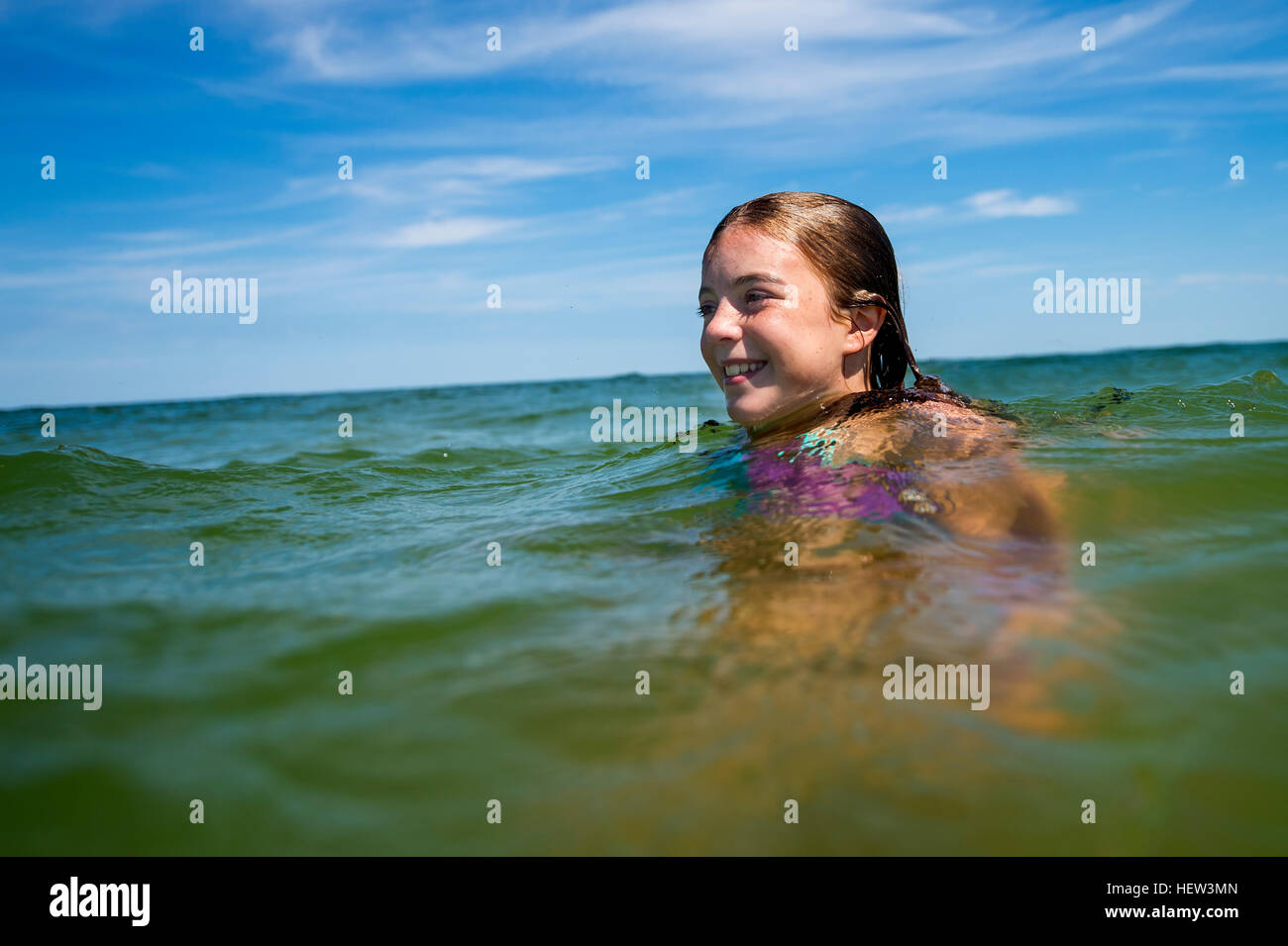 Girl wading in ocean Stock Photo - Alamy