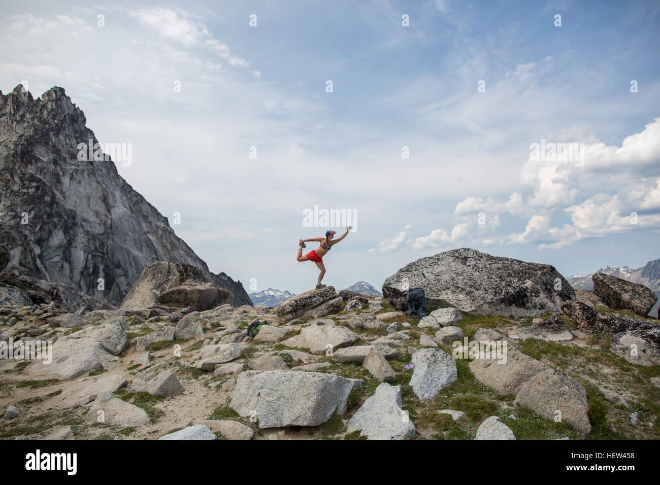 Young woman standing on rock, in yoga pose, The Enchantments, Alpine ...