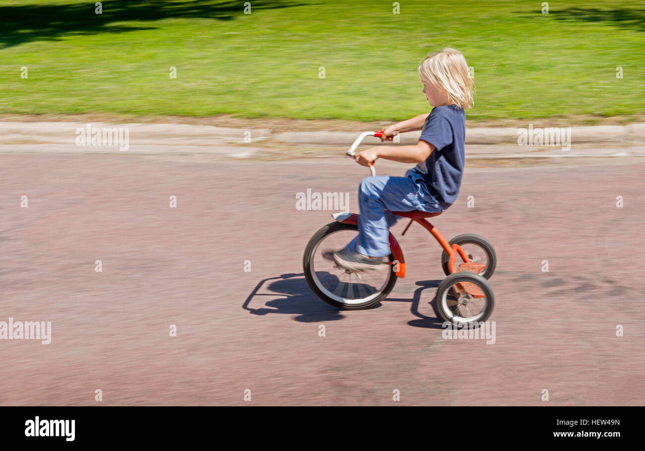 Boy with tricycle hi-res stock photography and images - Alamy