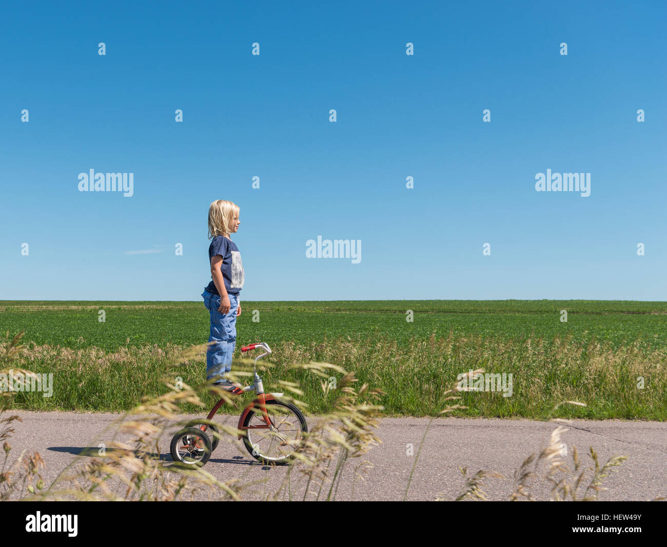 Boy and tricycle hi-res stock photography and images - Alamy