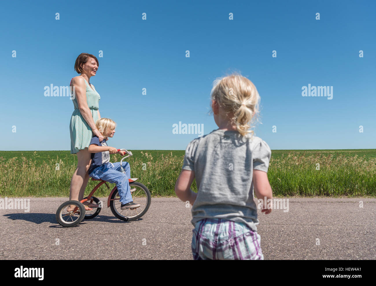 Woman riding tricycle hi-res stock photography and images - Alamy