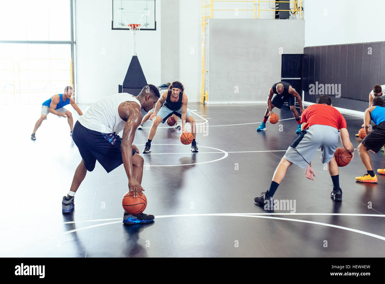 Male trainer and basketball team practicing on court Stock Photo - Alamy