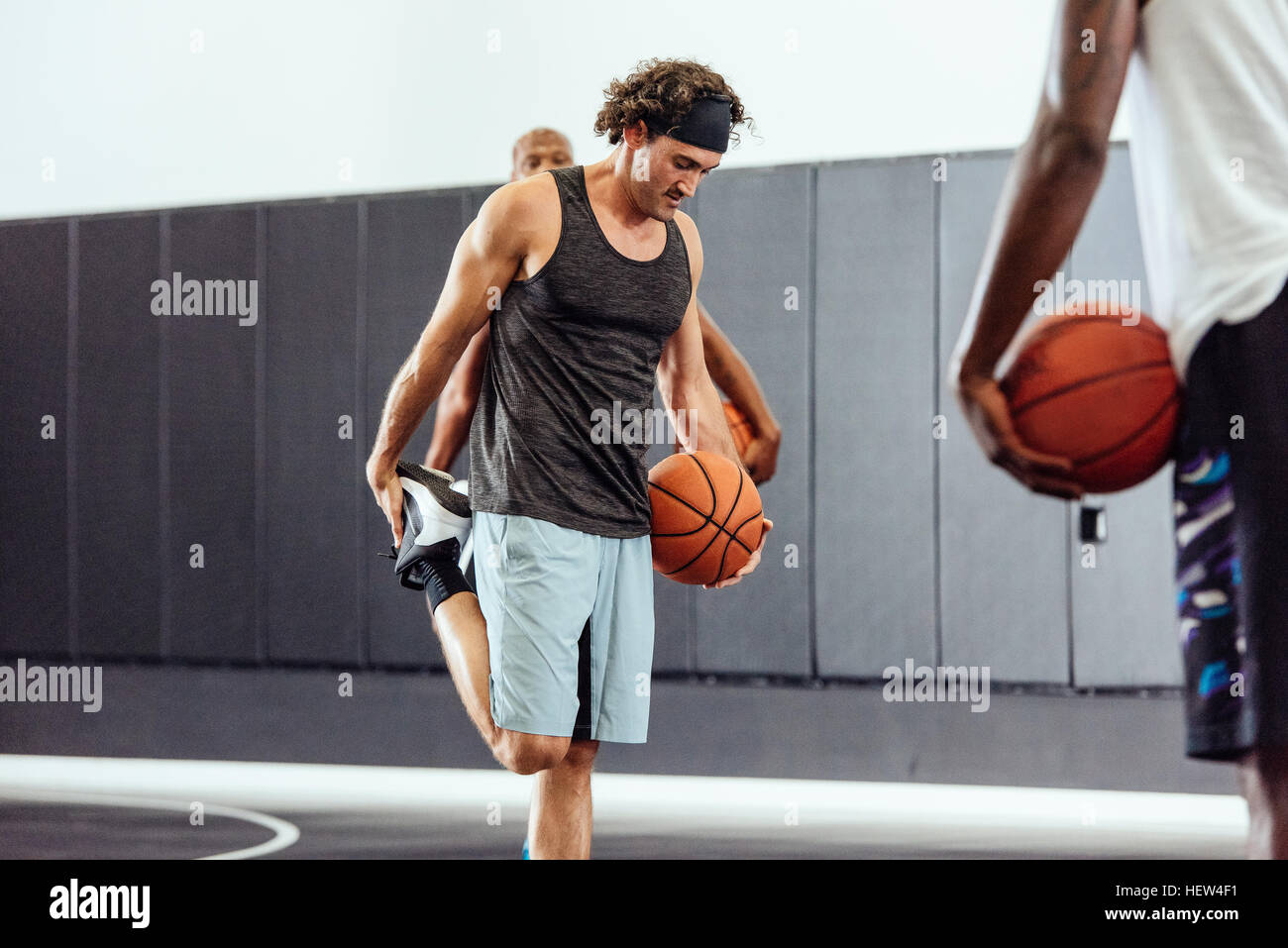 Male trainer and basketball players warming up on court Stock Photo - Alamy
