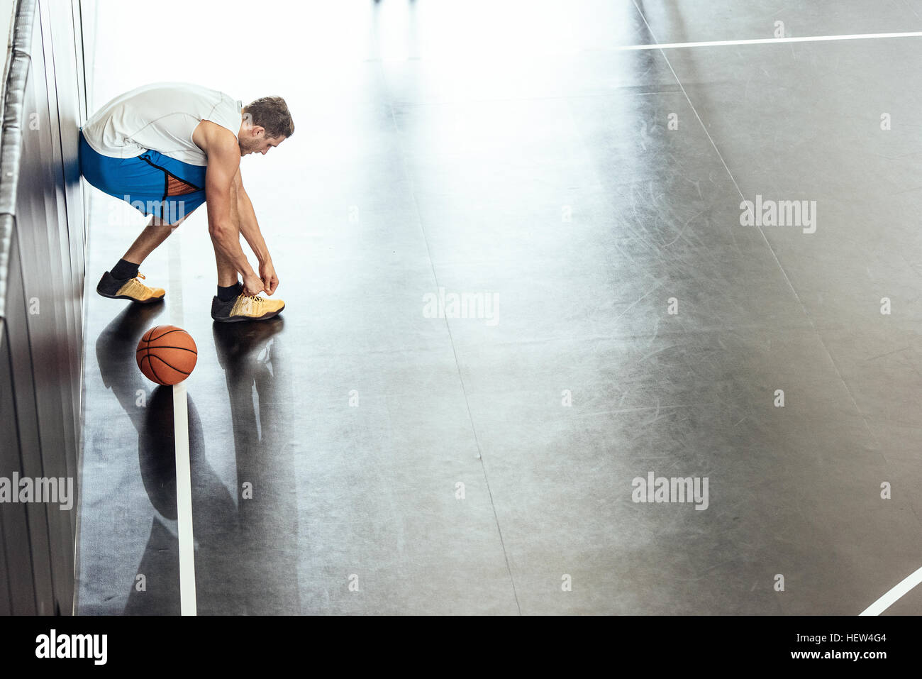 Male basketball player tying trainer hi-res stock photography and ...