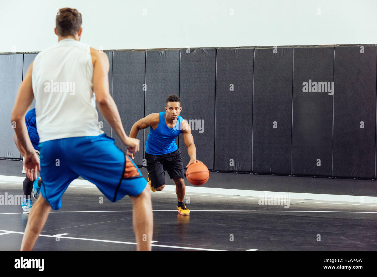 Male basketball player running with ball in basketball game Stock Photo ...
