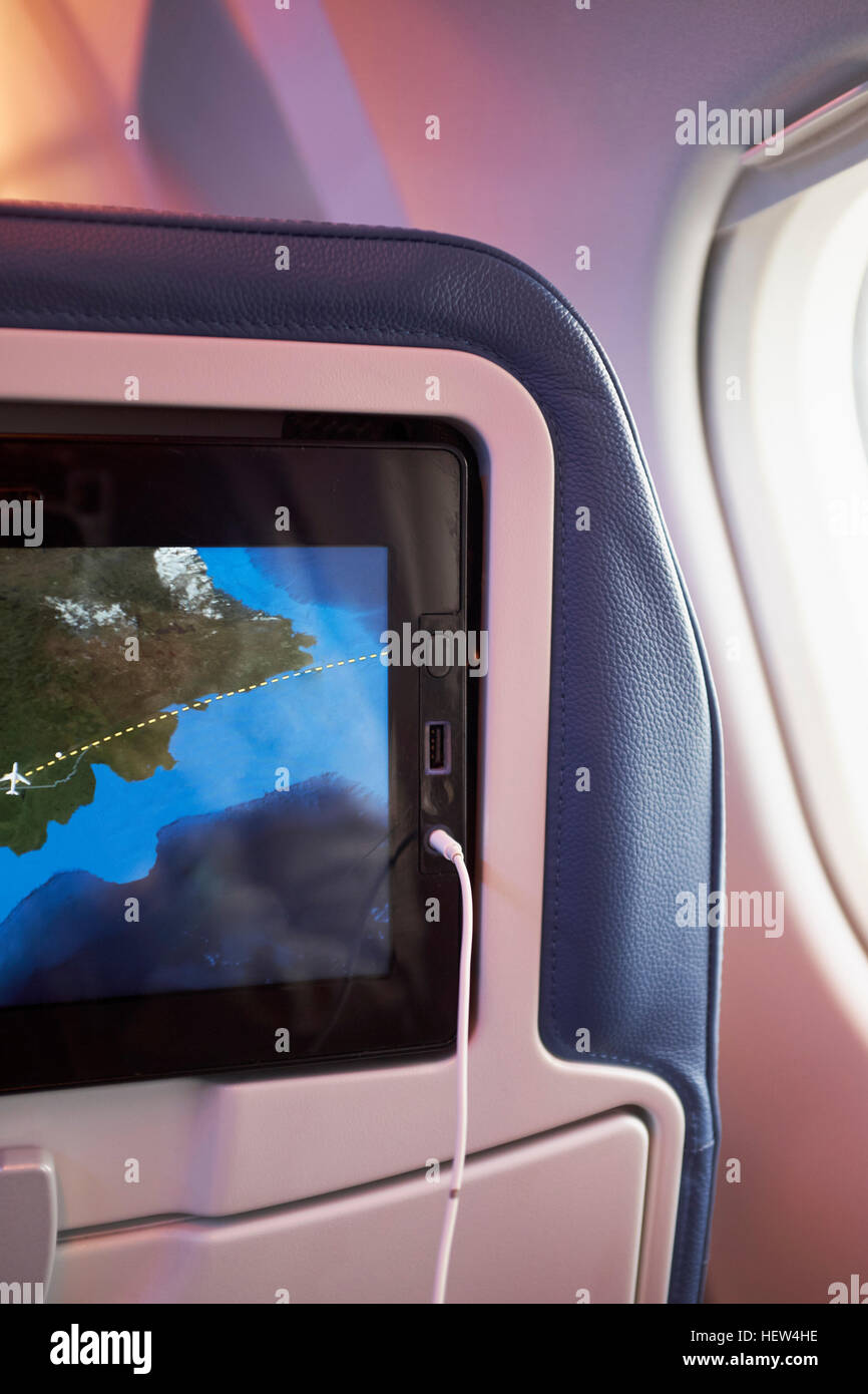 Computer screen route map on back of airplane seat Stock Photo - Alamy