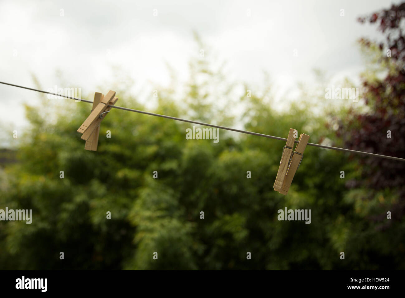 Wooden clothes pegs on washing line, close-up Stock Photo - Alamy
