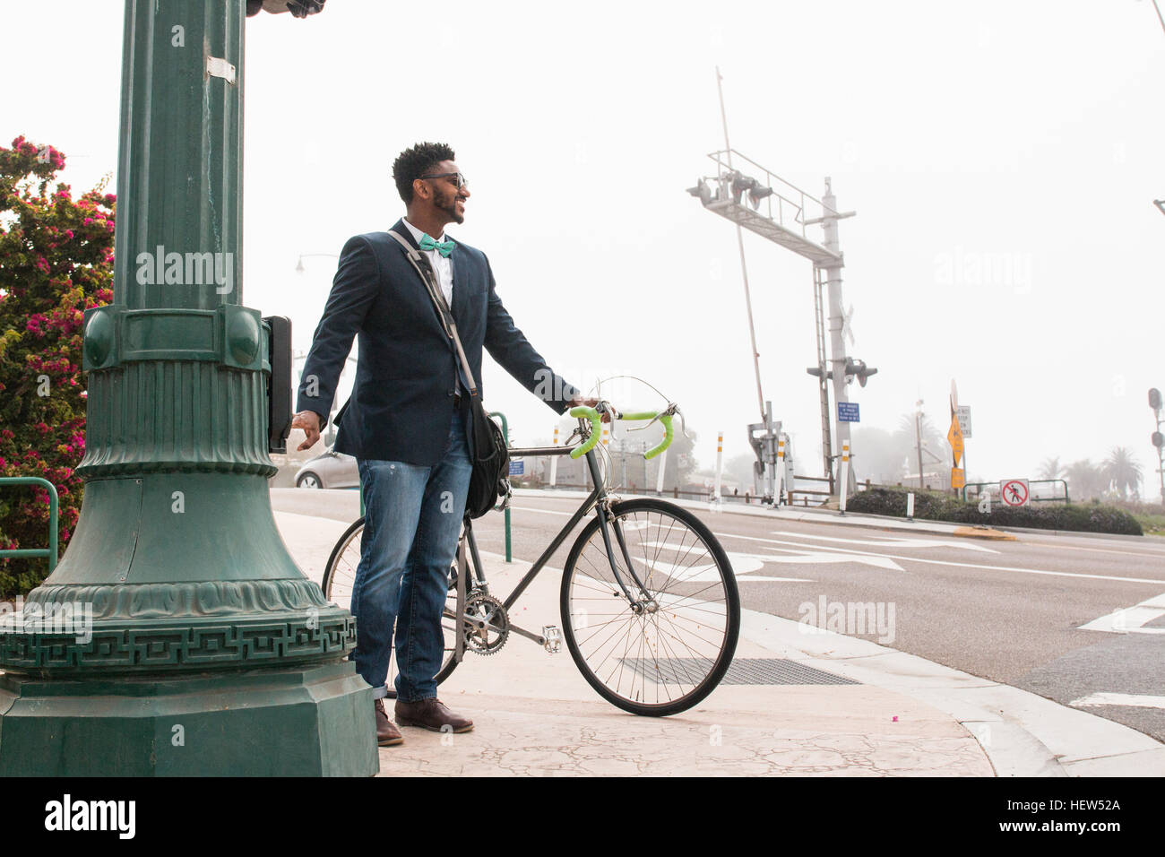 Young man walking outdoors with bicycle Stock Photo - Alamy
