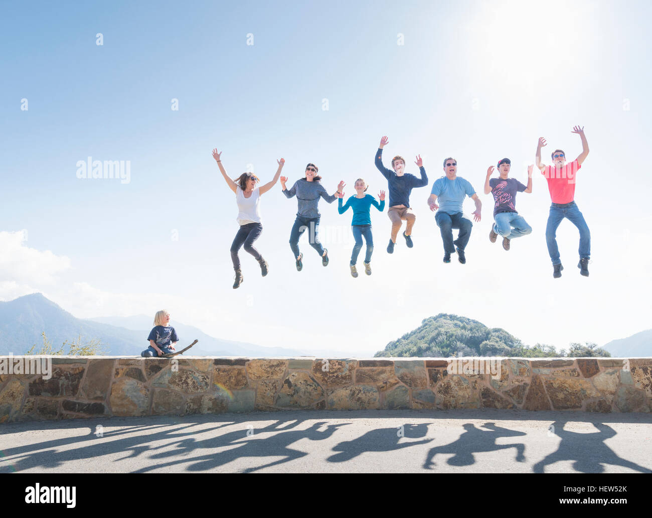 Group of people jumping in air, young boy sitting on wall, Sequoia ...