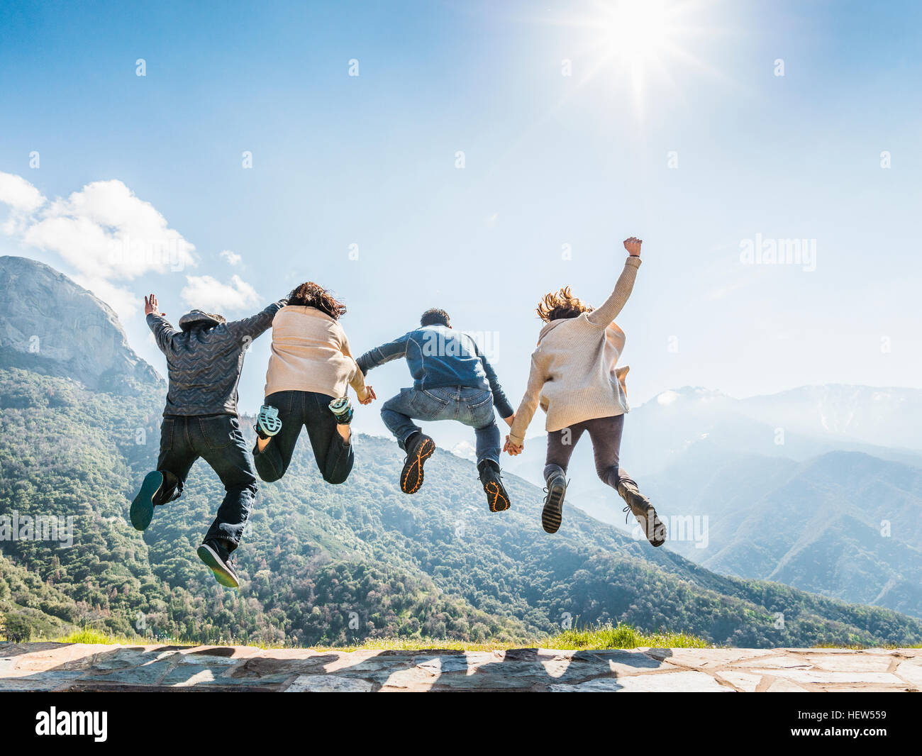 Group of people jumping in air, rear view, Sequoia National Park ...