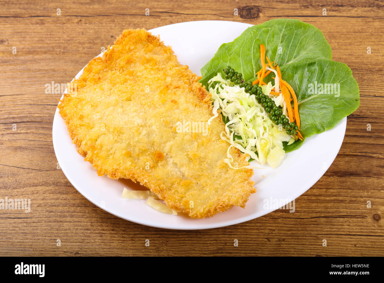 Fried Dory fish with salad on the wood background Stock Photo - Alamy