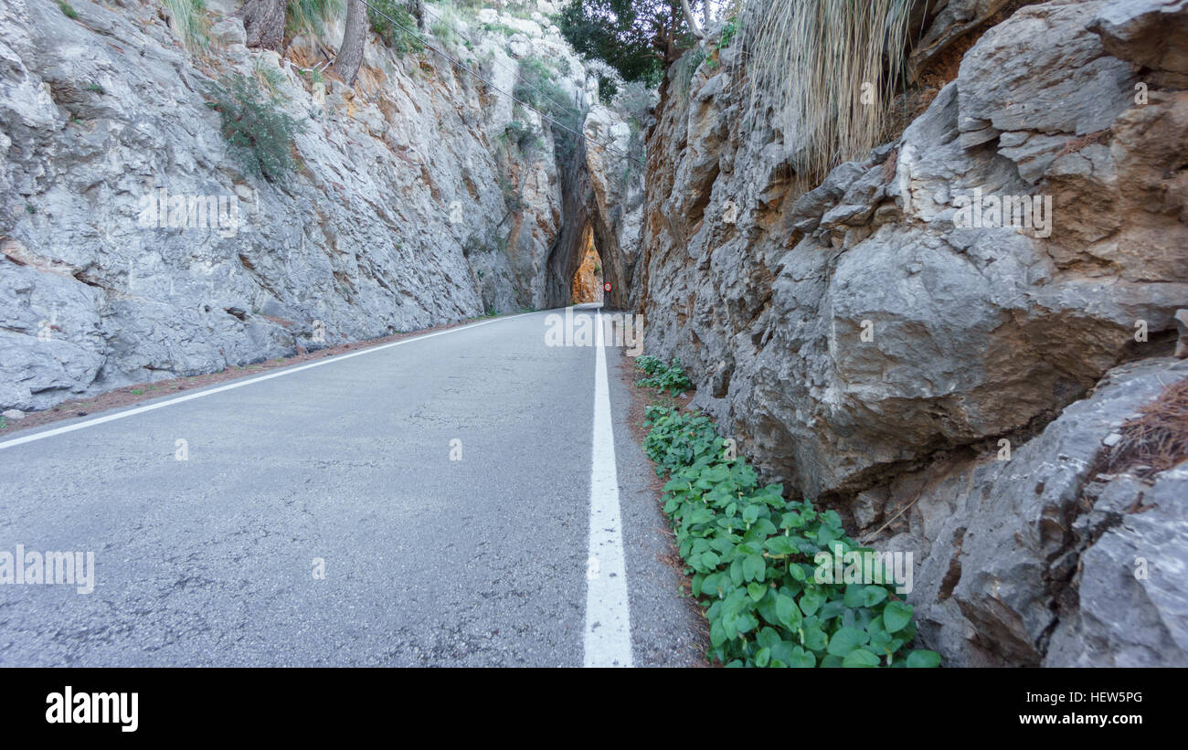 Asphalt road between rocks, wild track Stock Photo - Alamy