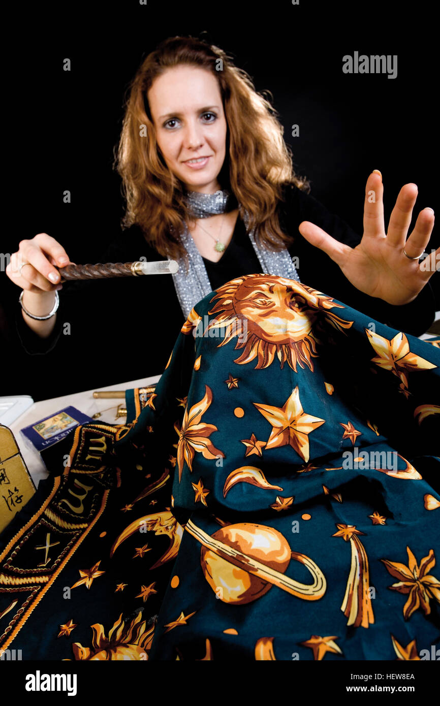 Fortune teller holding magic wand and astrology cloth Stock Photo - Alamy