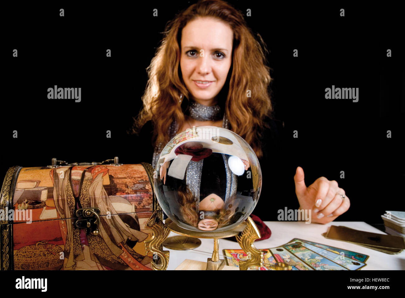 Fortune teller in front of a crystal ball with cards Stock Photo - Alamy
