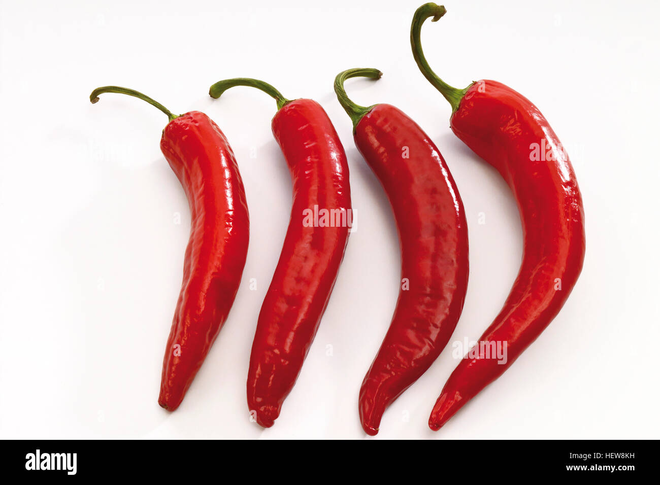 Four red hot chili peppers Stock Photo - Alamy