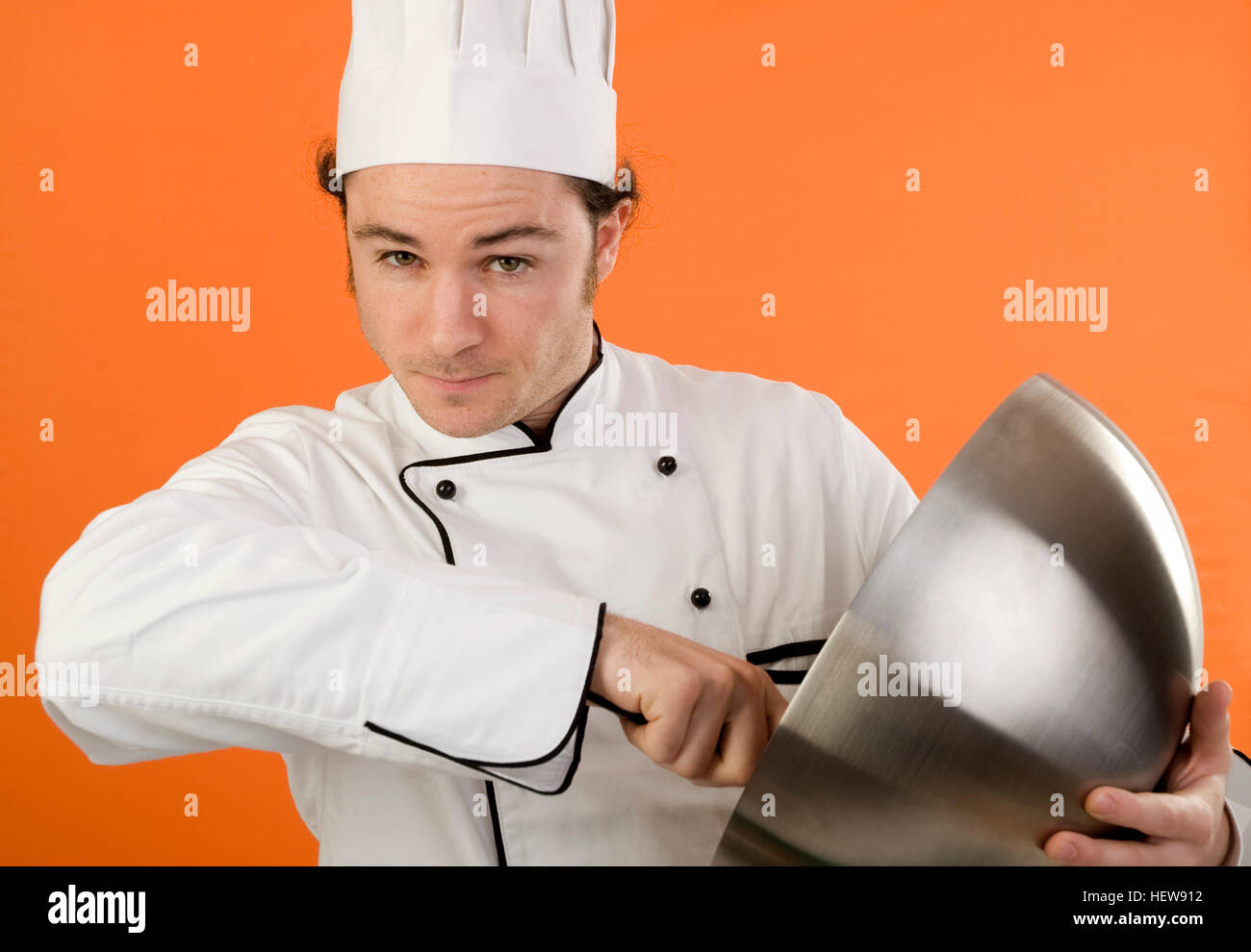Young chef holding mixing bowl Stock Photo - Alamy