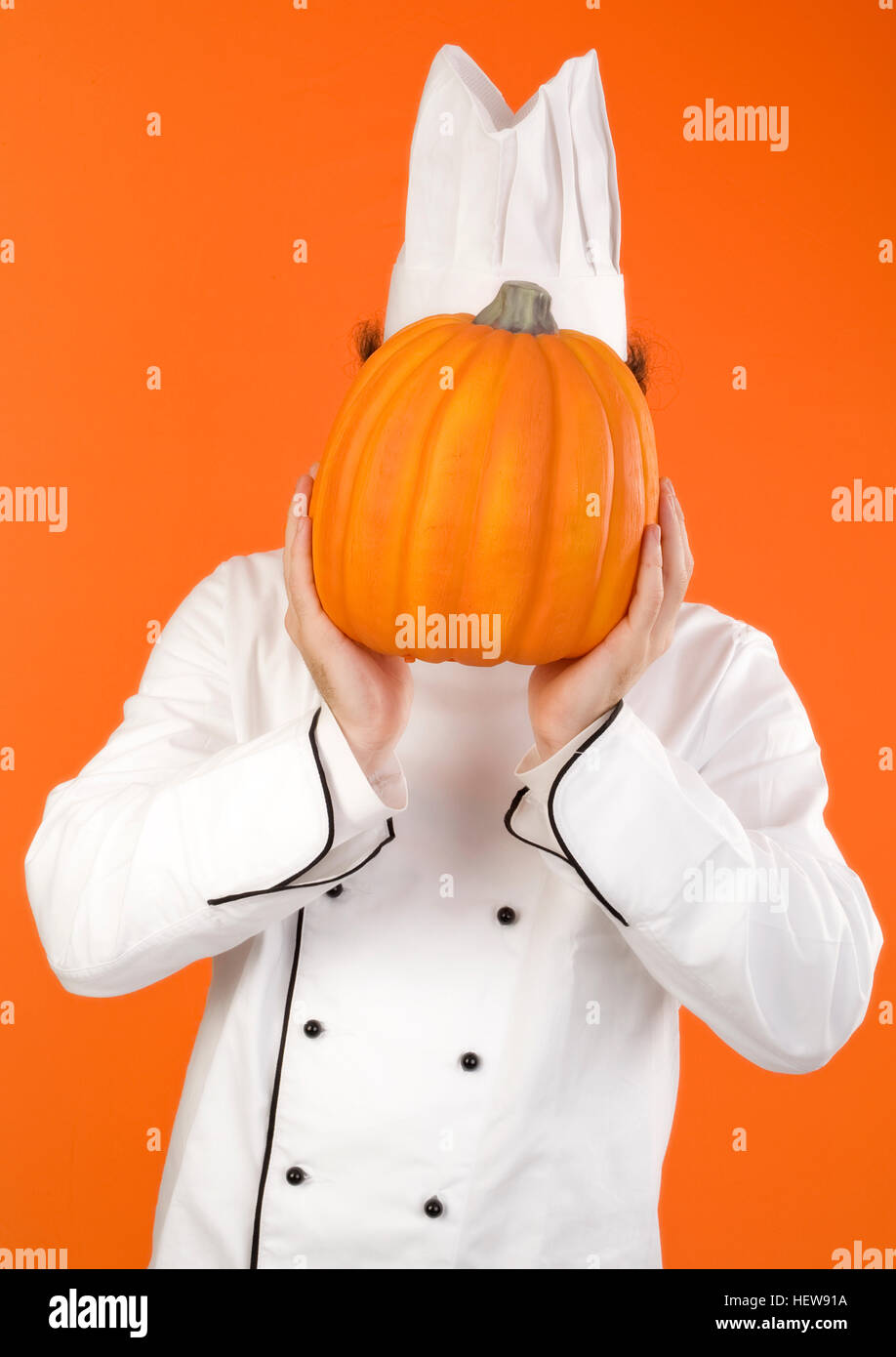 Chef holding a pumpkin in front of his face Stock Photo - Alamy