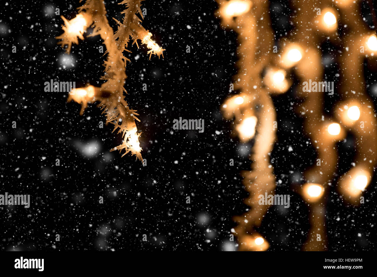 white christmas lights on roof against dark background with icing and ...