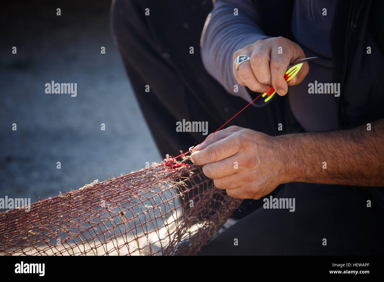 Fisherman fixing nets hi-res stock photography and images - Alamy