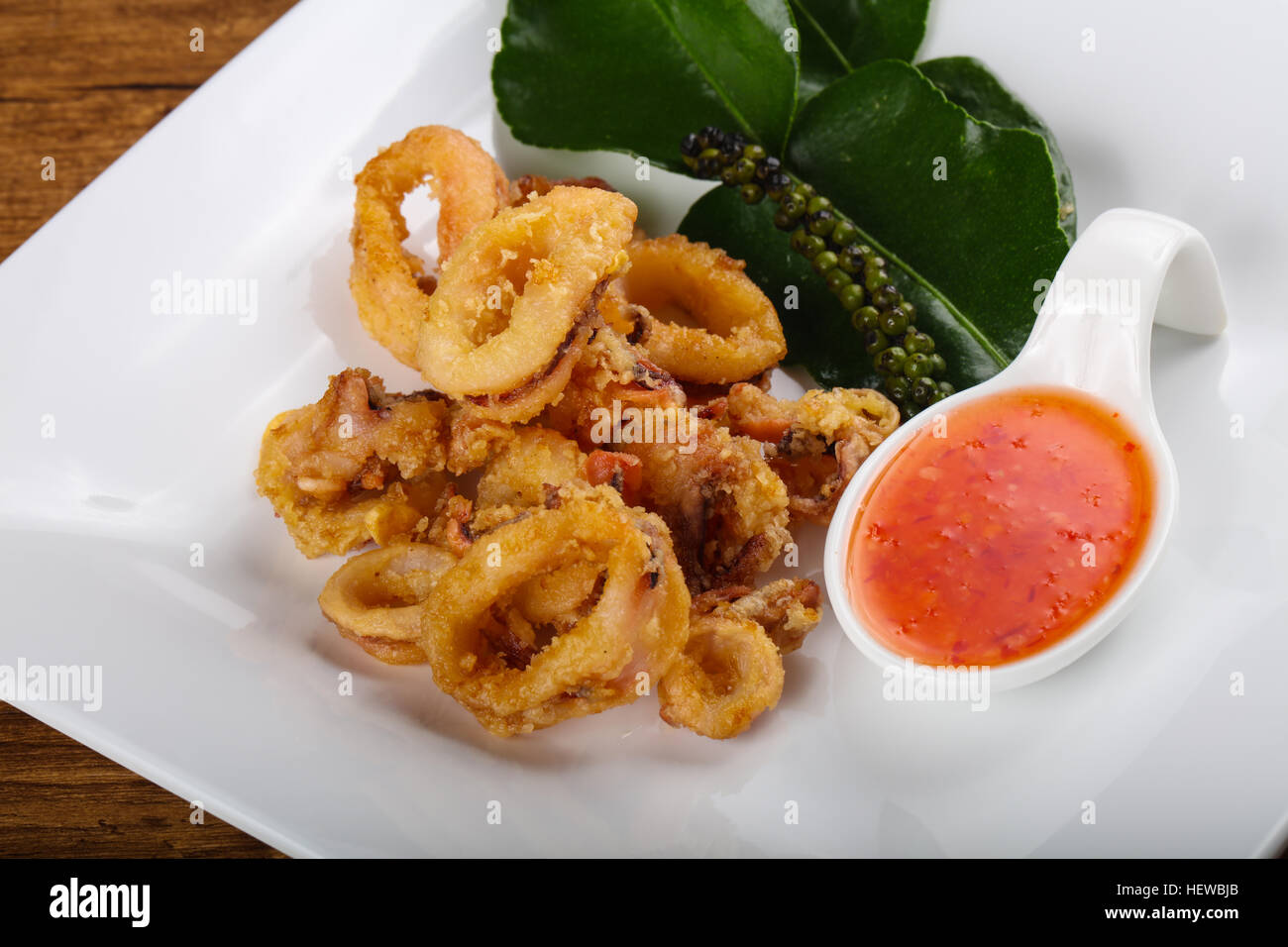 Fried squid rings with hot spicy sauce Stock Photo - Alamy