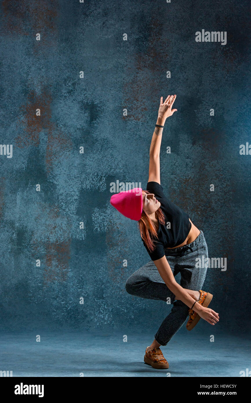 Young girl break dancing on blue studio background Stock Photo - Alamy