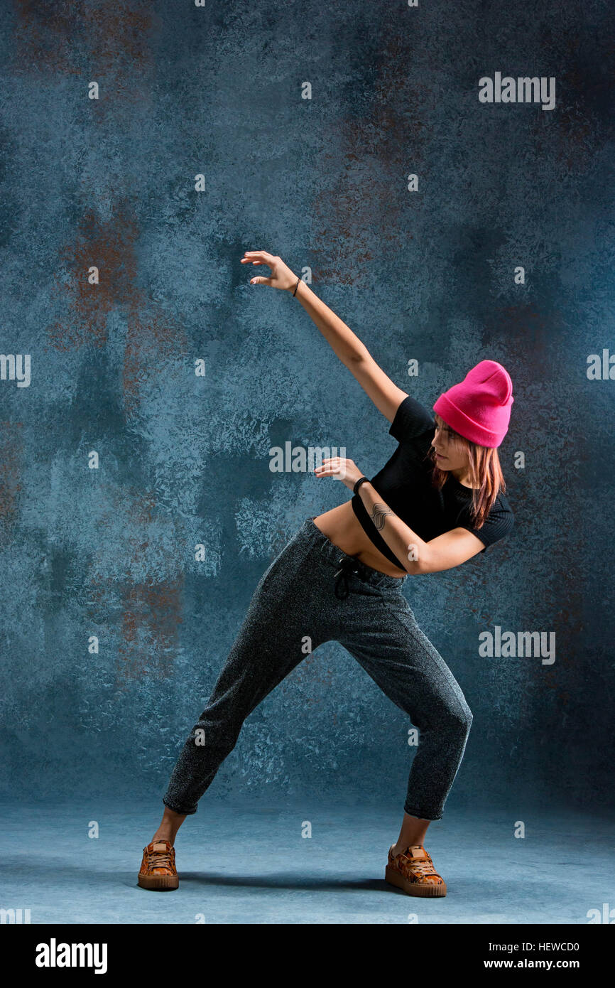 Young girl break dancing on blue studio background Stock Photo - Alamy
