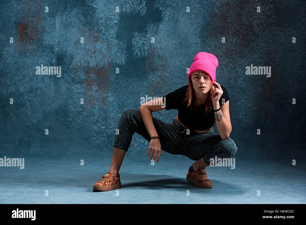 Young girl break dancing on blue studio background Stock Photo - Alamy