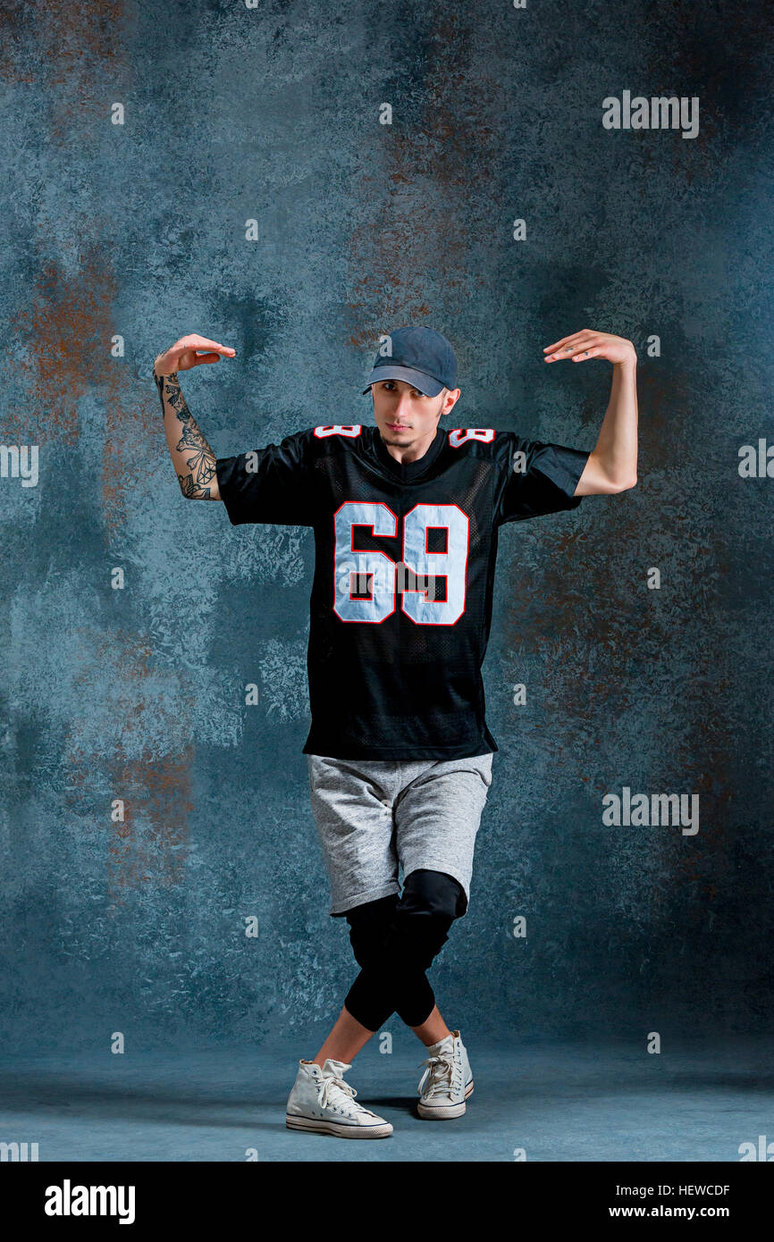 Young man break dancing on blue studio background Stock Photo - Alamy