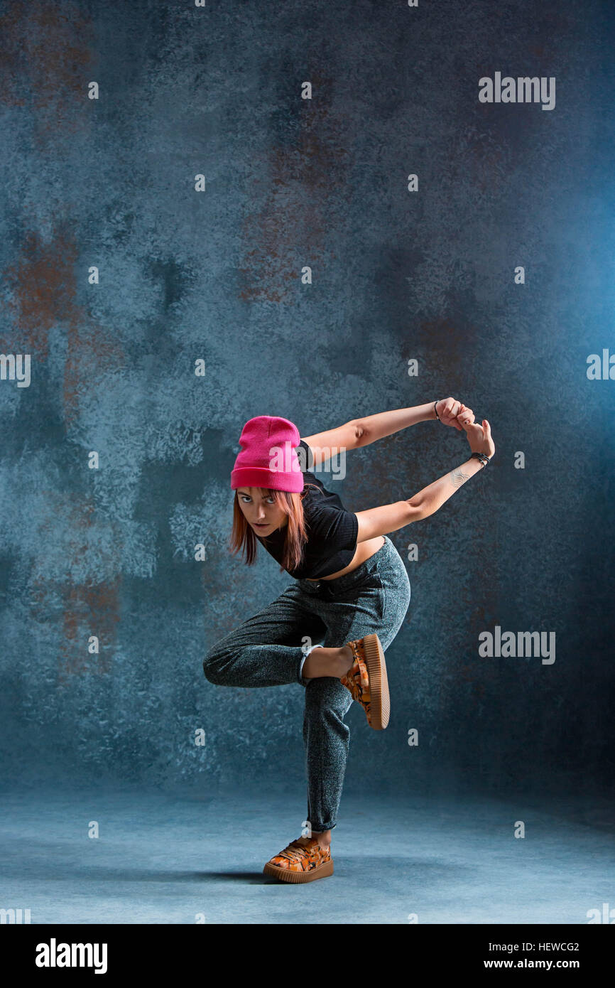 Young girl break dancing on blue studio background Stock Photo - Alamy