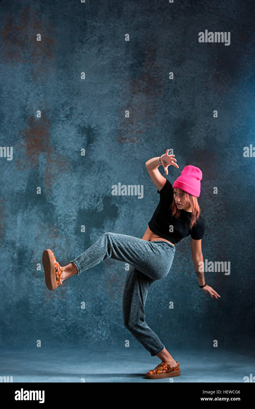 Young girl break dancing on blue studio background Stock Photo - Alamy