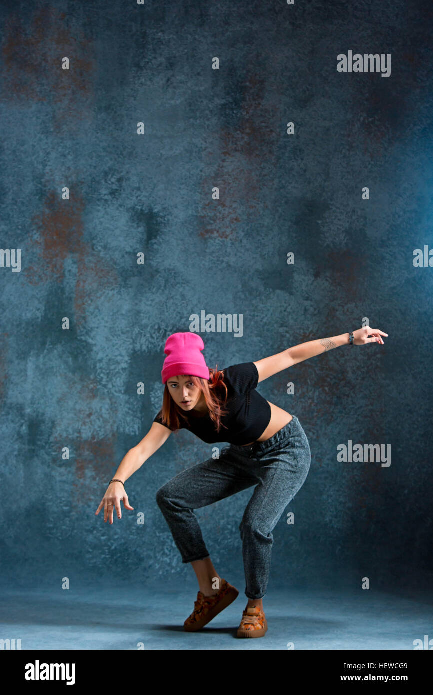 Young girl break dancing on blue studio background Stock Photo - Alamy