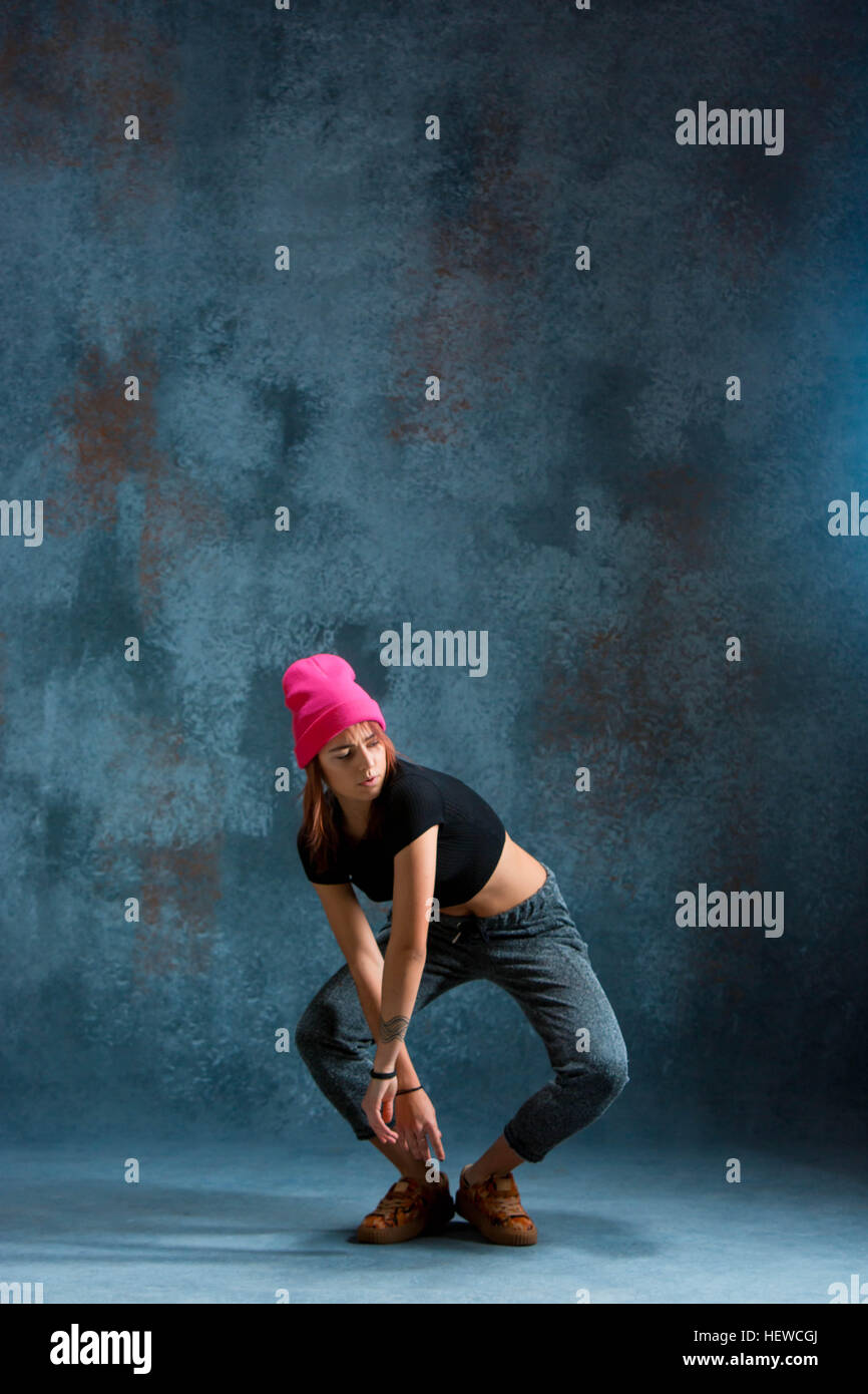 Young girl break dancing on blue studio background Stock Photo - Alamy