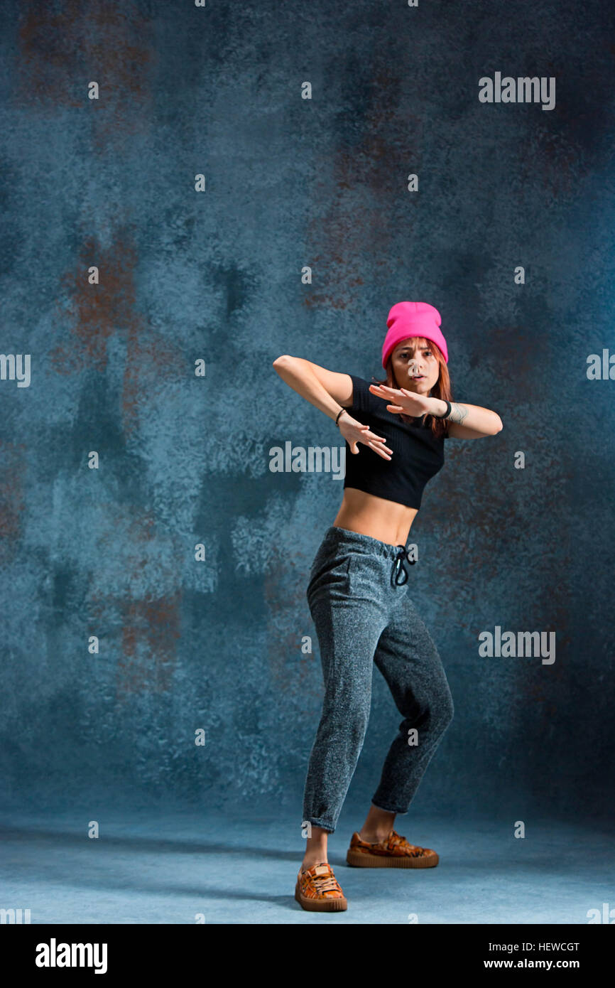 Young girl break dancing on blue studio background Stock Photo - Alamy