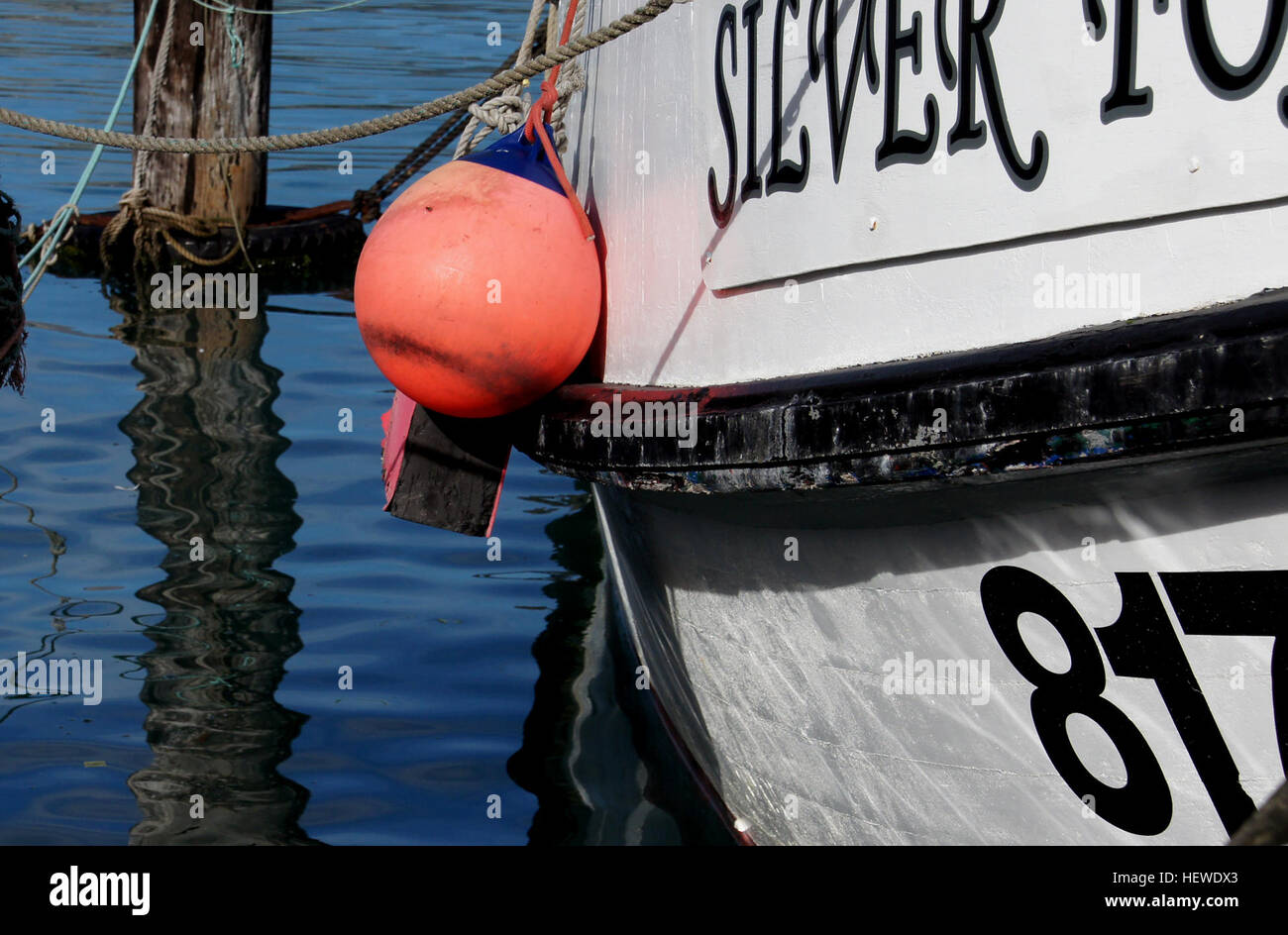 This image features a red fishing float and buoy, commonly used for ...