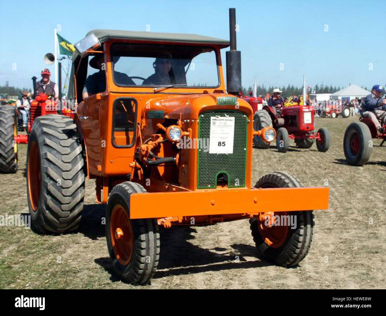 The orange tractor is a common agricultural vehicle used in farming and ...