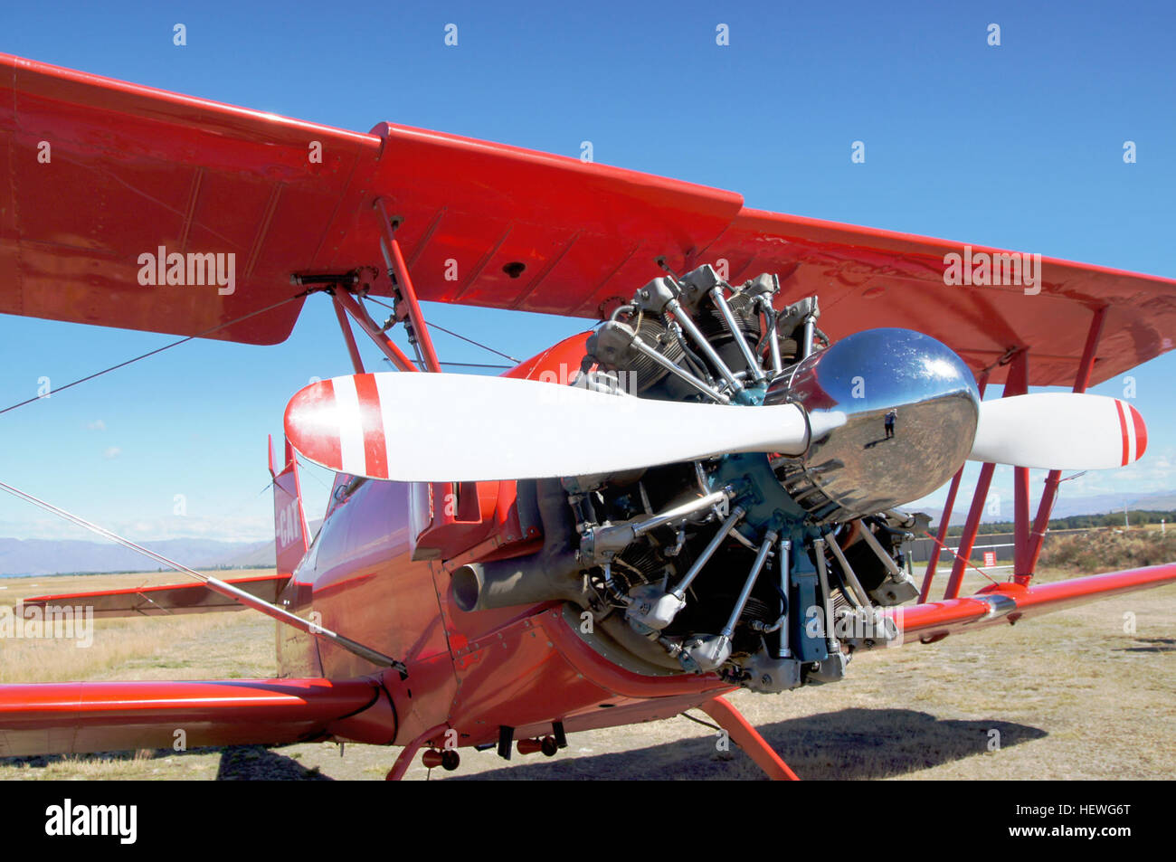 The red Grumman Ag-Cat biplane, powered by a radial engine, flies over ...