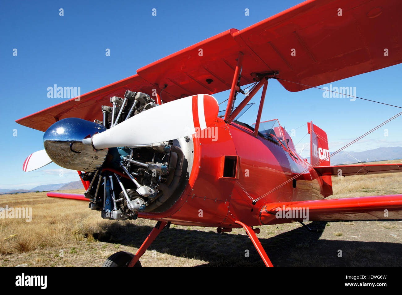 A red Grumman biplane, powered by a radial engine, pictured at Pukaki ...