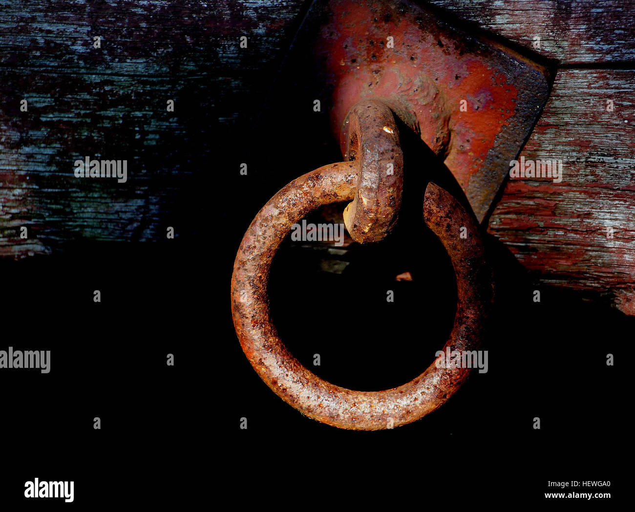 A close-up photograph of a rusty metal ring, showing signs of corrosion ...