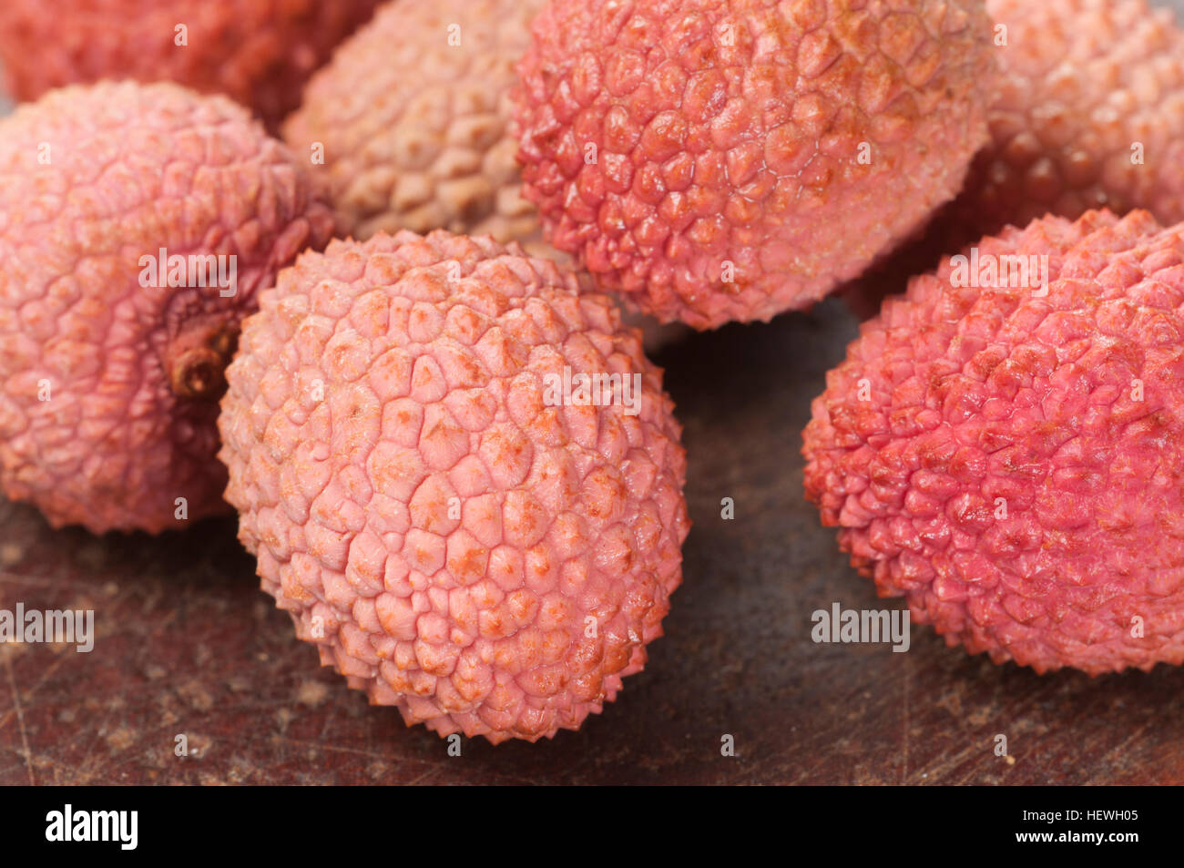 Lychee berries on a timber board, close up Stock Photo - Alamy